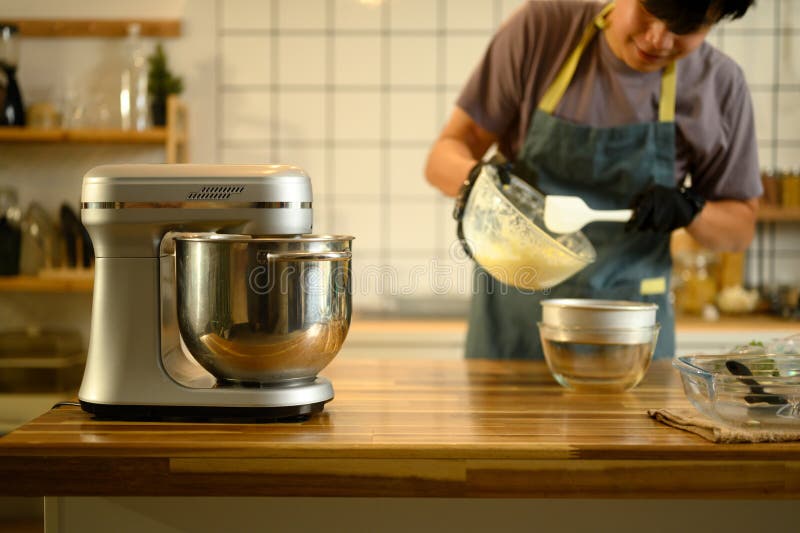 An Electric Mixer Stands Countertop with Blurred Background of Man ...