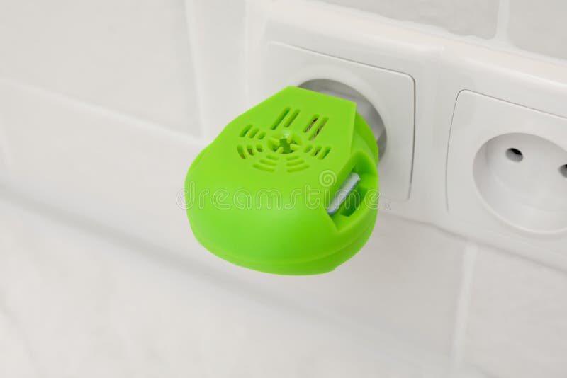 Electric Mosquito Device with Insect Repellent Plate Plugged in Socket ...