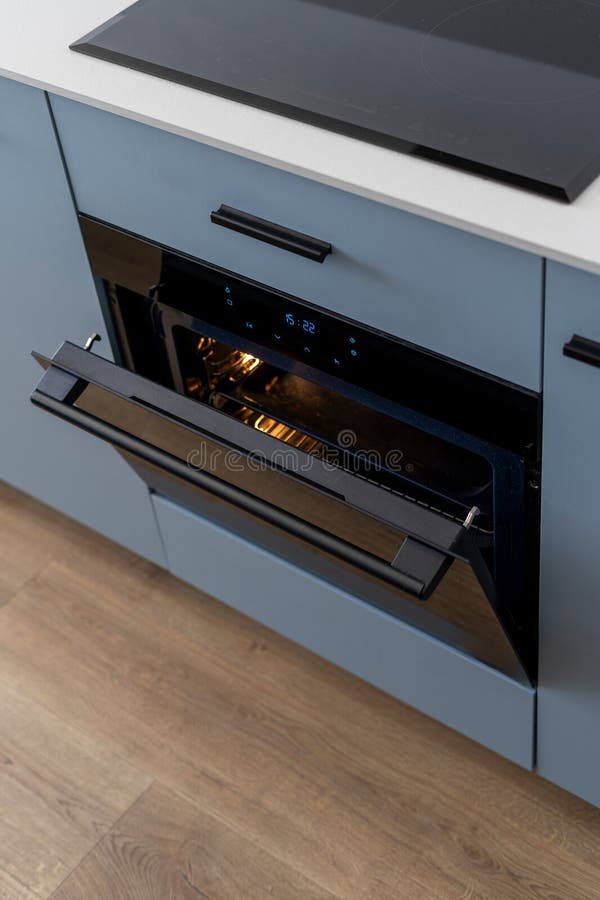 Electric Oven with Opened Door and Light Inside in Modern Kitchen Stock ...
