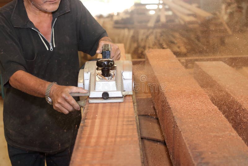 Electric Planer is Being Worked with Hands of Senior Carpenter in ...