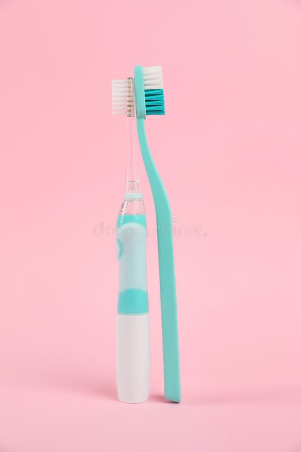 Electric and Plastic Toothbrushes on Pink Background. Dental Care Stock ...