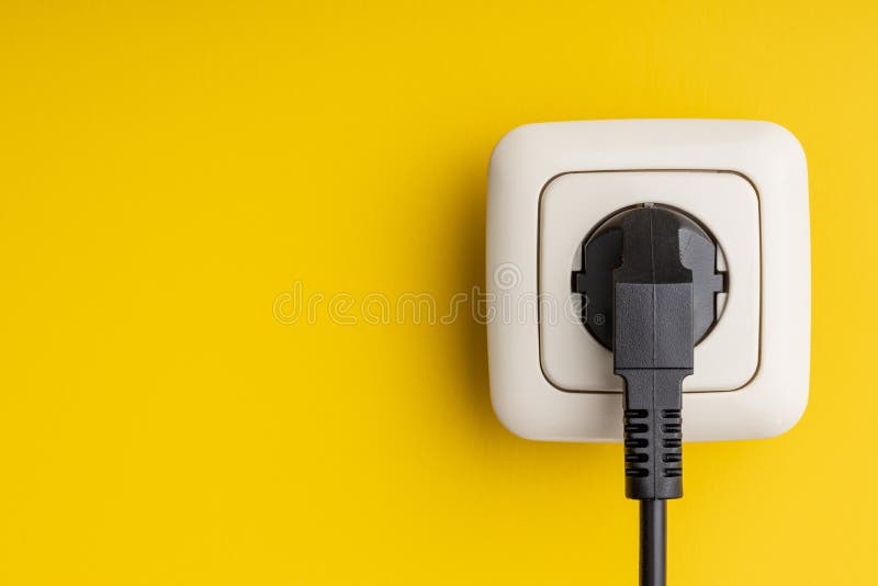 Electric Plug and Wall Socket on Yellow Wall Stock Image - Image of ...