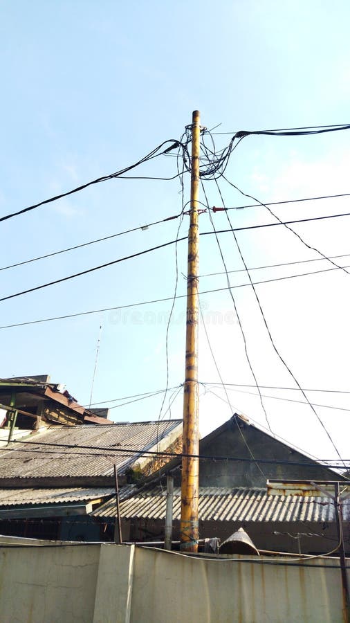 Electric Pole in Front of the House with Bright Clouds As a Background ...