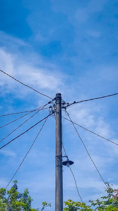 An Electric Pole with a Lamp and Some Wires in Fine Weather and Several ...