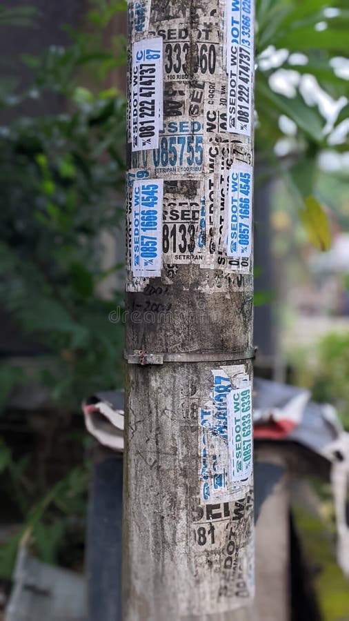 An Electric Pole with a Sticker Attached To a Promotion for Cleaning ...