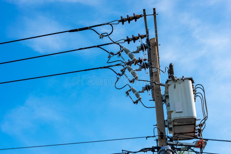 An Electric Pole with Transformer High Voltage on Blue Sky Background ...