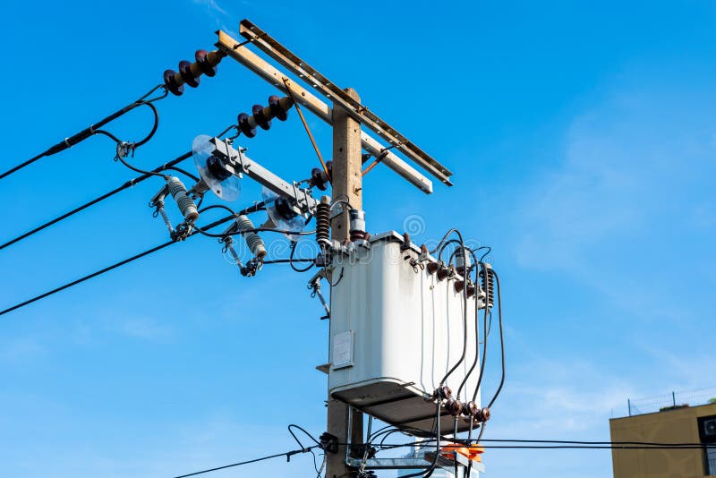 An Electric Pole with Transformer High Voltage on Blue Sky Background ...