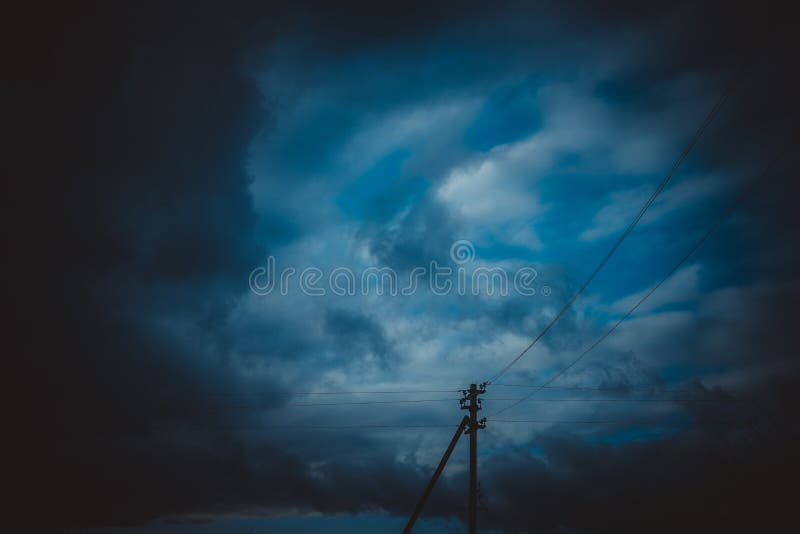 Electric Pole, the Wires are in the Form of a Triangle, Dark Cloudy Sky ...