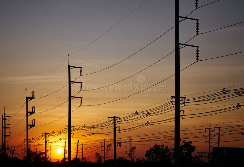 The Electric Poles and Electric Lines with a Sky of Sunset Stock Image ...