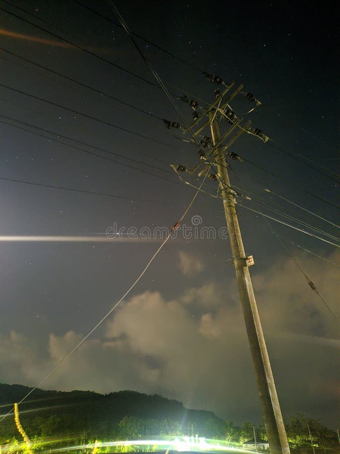 Electric poles at night stock photo. Image of beautiful - 201192150
