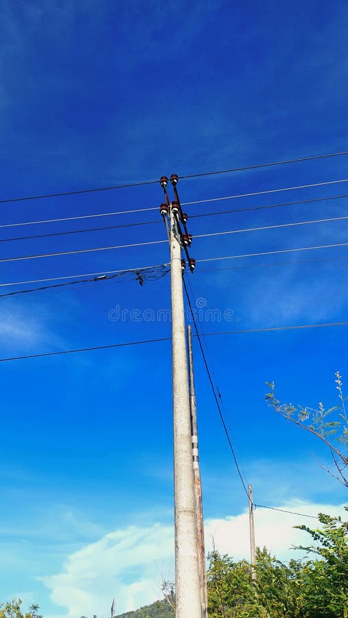 Electric Poles and Power Lines with White Clouds and Clear Blue Sky ...