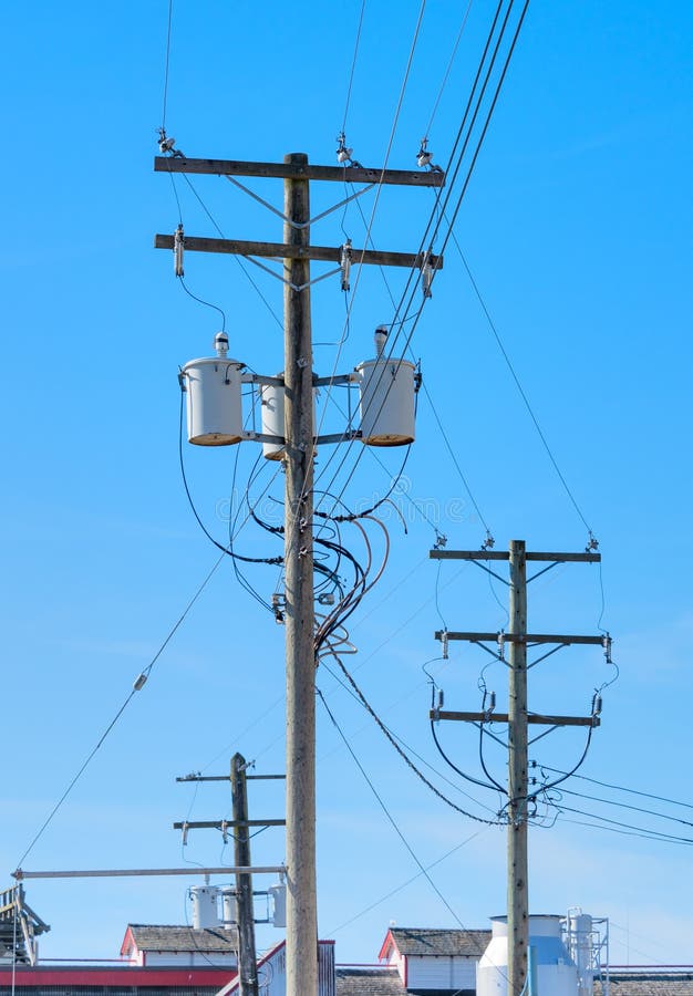 Wooden Electricty Pole with Mounted Transformators on Blue Sky ...
