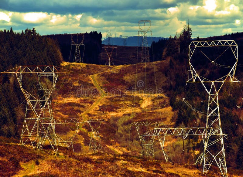 Electric Power Lines in an Empty Field Under the Cloudy Sky Stock Photo ...