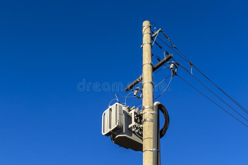 Electric Power Transformer on a Pole with Blue Sky Background Stock ...