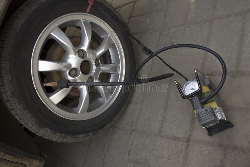 Electric Pump Inflates the Wheel in the Car Stock Image - Image of ...