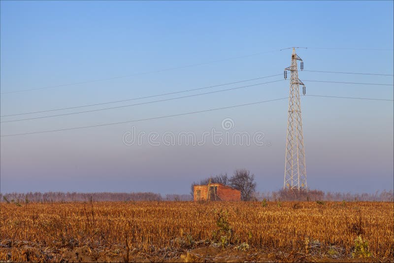 Electric Pylon and Small Rural Building in the Countryside on Corn ...