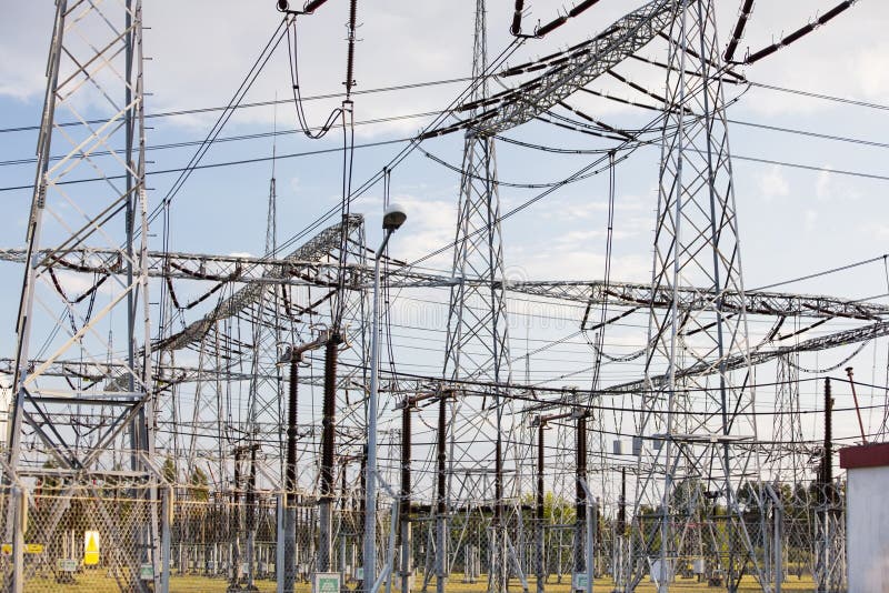 Electric Pylons at Power Plant Stock Photo - Image of power, clouds ...