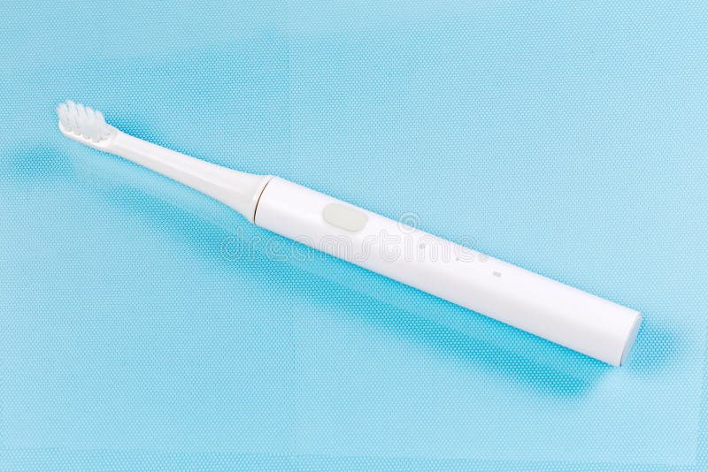Electric Rechargeable Toothbrush on a Blue Surface Stock Image - Image ...