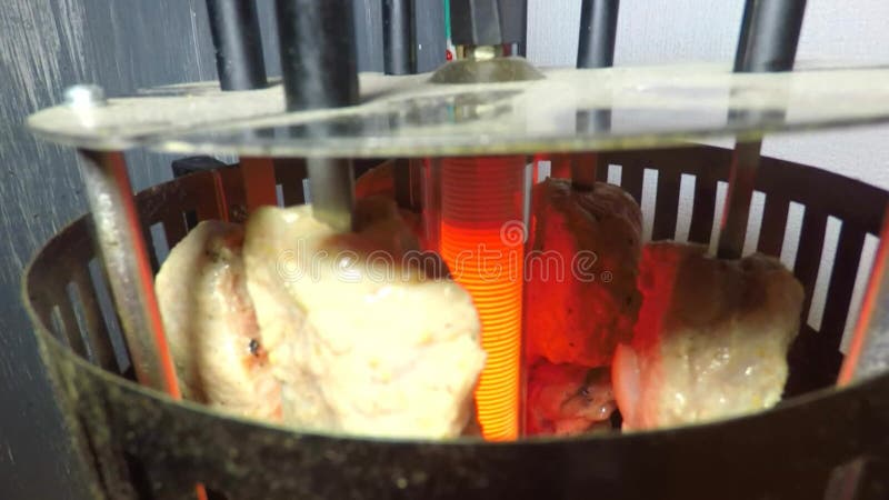 The Electric Skewer on a Spit Roasts Meat that Rotates Stock Video ...