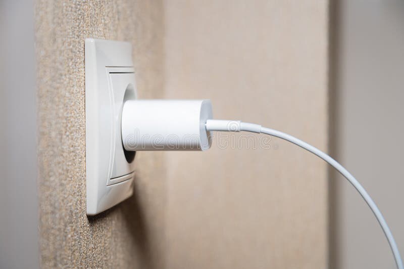 Electric Socket on a Pink Wall. the Black Wire Plug is Connected ...
