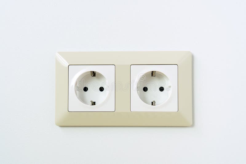 Electric Socket on White Wall. Double White Plastic Power Outlet Stock ...