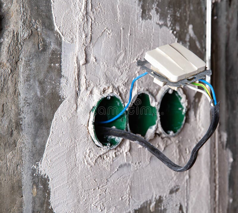 An Electric Switch Hangs on Wires from Socket Boxes Built into a ...