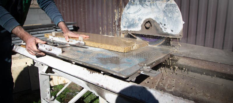 Electric Tile Cutter. Tiler Cutting Tile on Wet Saw Machine Stock Photo ...