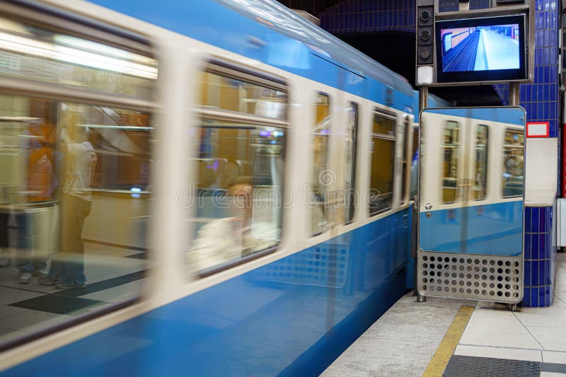 An Electric Train with Metro Passengers in an Underground Metro Station ...