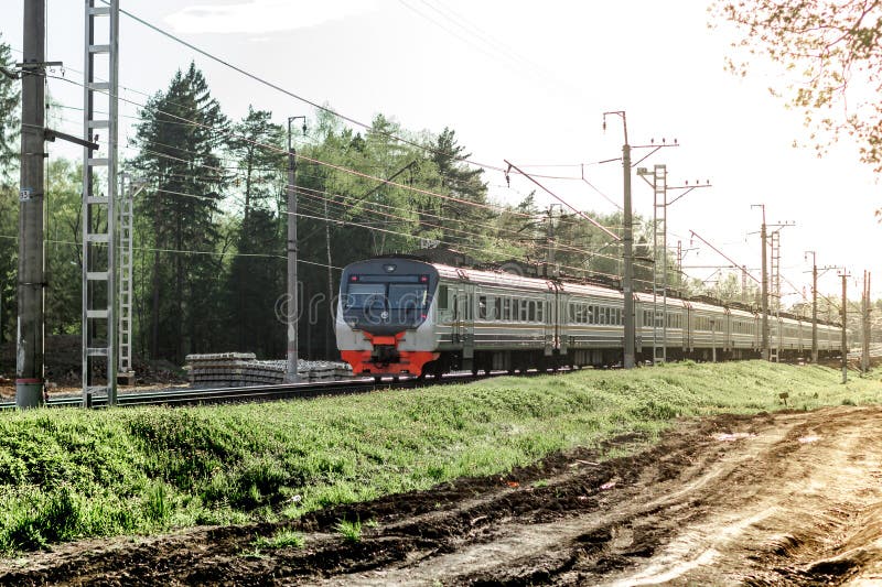 An Electric Train is Moving Slowly Along the Railway Tracks through the ...