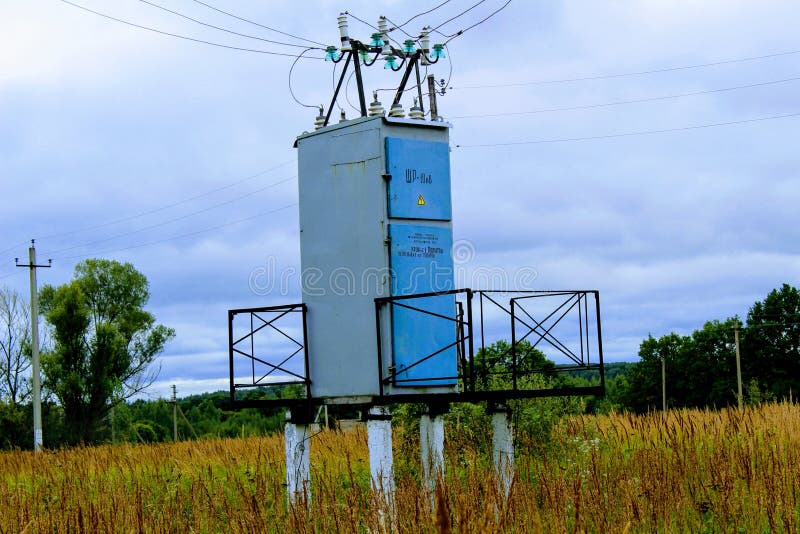 An Electric Transformer Standing in the Middle of the Field Stock Photo ...