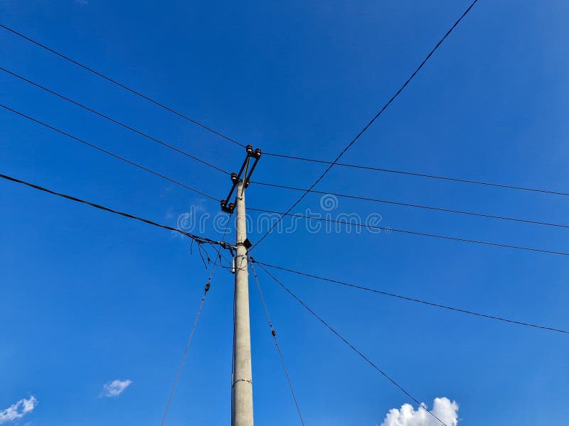 Electric Utility Pole with Multiple Cables Stretching Across a Clear ...