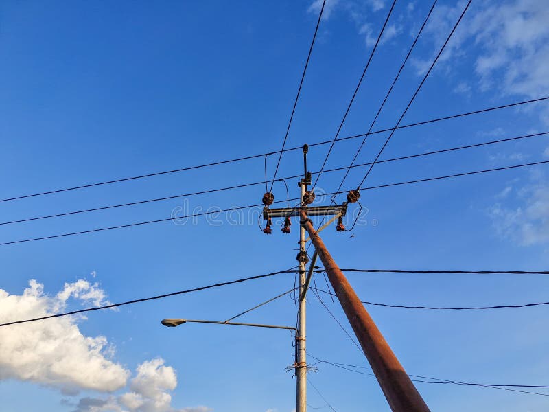 Electric Utility Pole with Multiple Cables Stretching Across a Clear ...