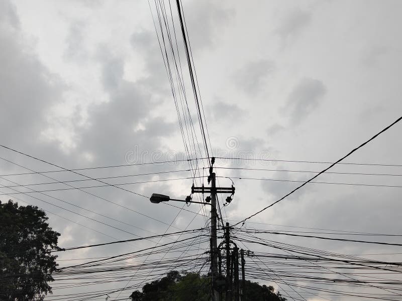 Electric Utility Pole with Tangled Wires Against Overcast Sky Stock ...