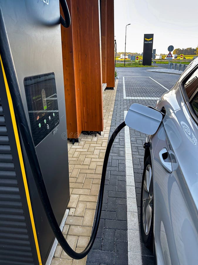 Electric Vehicle Being Refueled at a Charging Station Editorial Image ...