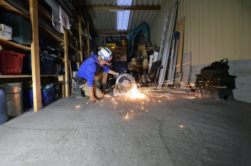 Electric Wheel Grinding on Steel Pipe in Work Space. Stock Photo ...