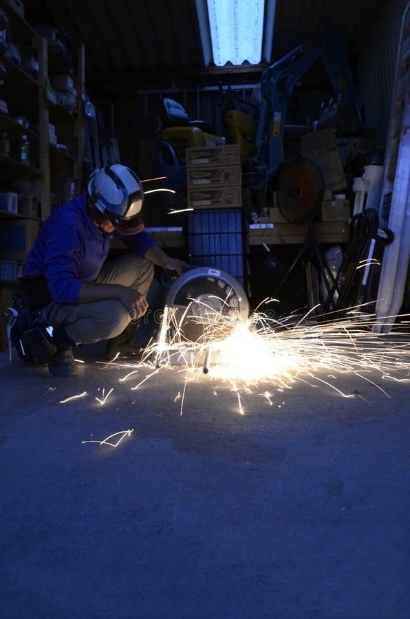 Electric Wheel Grinding on Steel Pipe in Work Space. Stock Photo ...