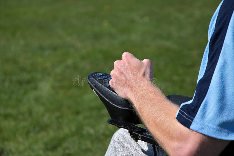 Electric Wheelchair. Young Man Controls a Wheelchair with His Left Hand ...