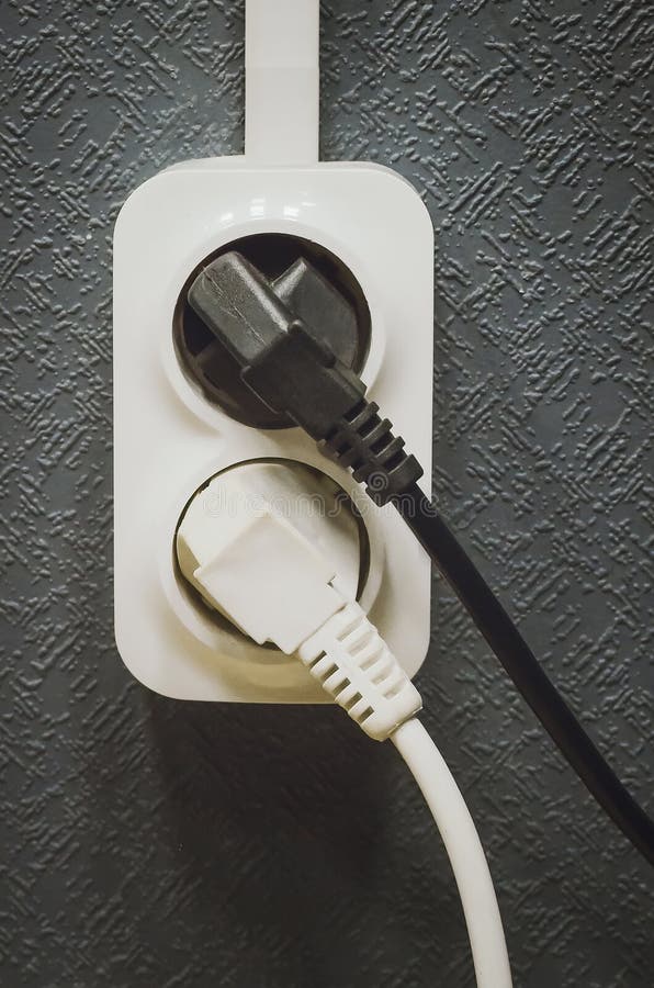 Electric White and Black Plugs and a White Plastic Plug on the Wall ...