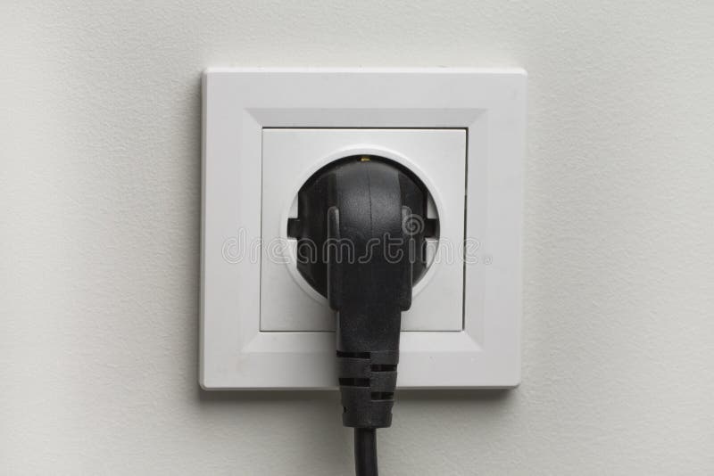 Electric White Socket and One Plugged in Power Cord on White Wall ...