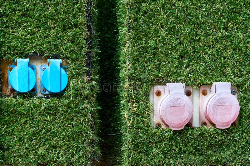 Electric Sockets for Charging on a Pole with Artificial Green Grass in ...