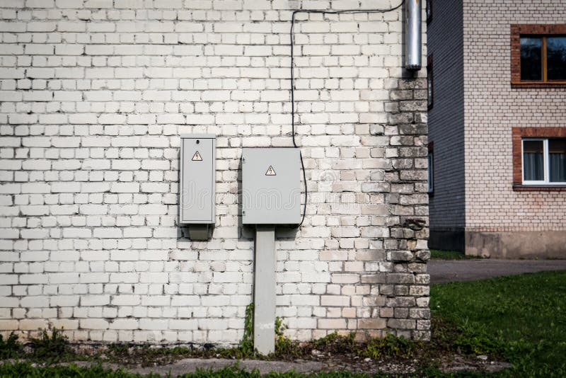 Electrical Distribution Boxes Against a White Brick Wall Stock Image ...
