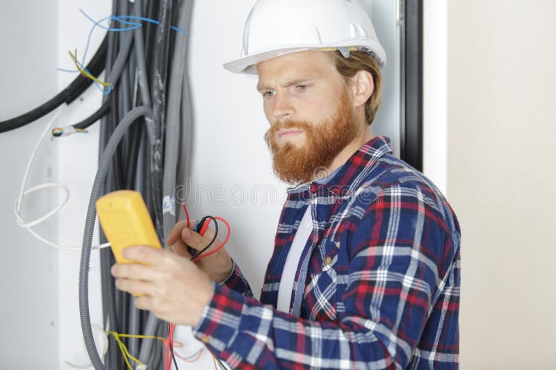 Electrical Engineer Adjusts Electrical Equipment with Multimeter Stock ...