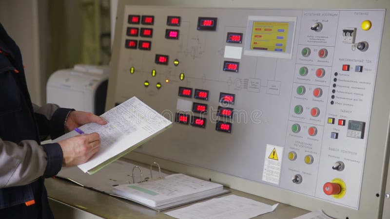 Electrical Engineer Checking Parameters at a Control Panel of a Nuclear ...
