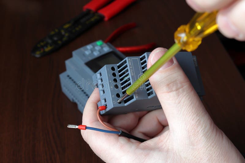 The Electrical Engineer Connects the Power Cable To the Power Supply ...