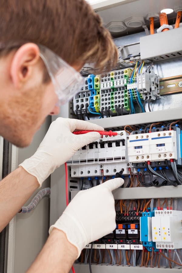 Electrical Engineer Examining Fusebox with Multimeter Probe Stock Image ...