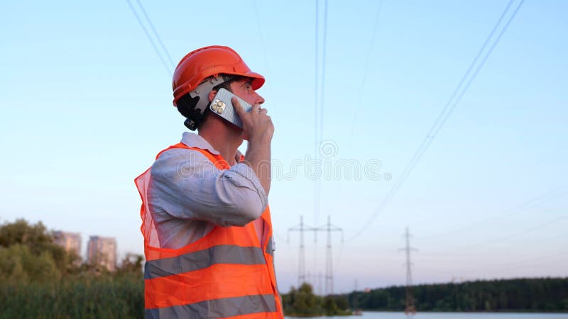 Electrical Engineer in Helmet Checking Power Line while Talking on the ...