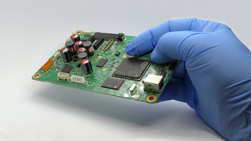 Electrical Engineer Holding a Circuit Board with Microchips in His Hand ...
