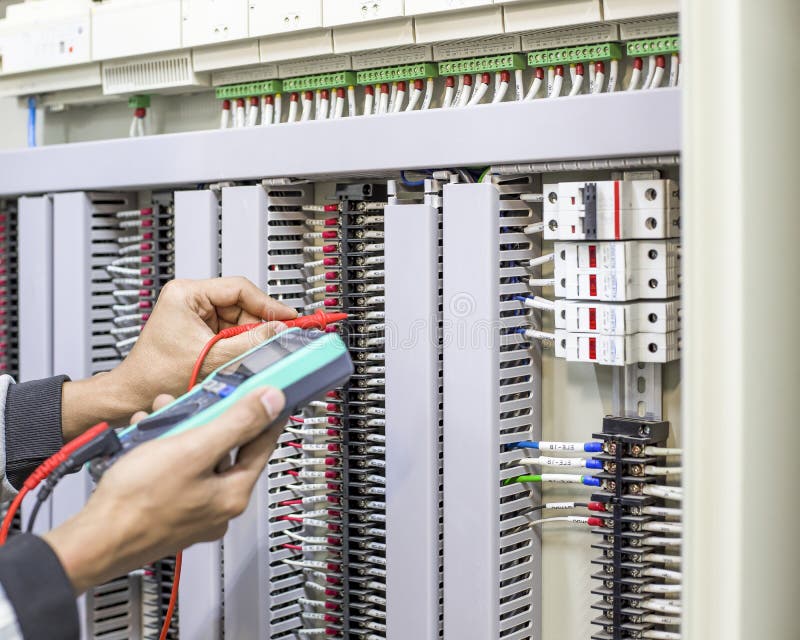Electrical Engineer Tests the Operation of the Electric Control Cabinet ...