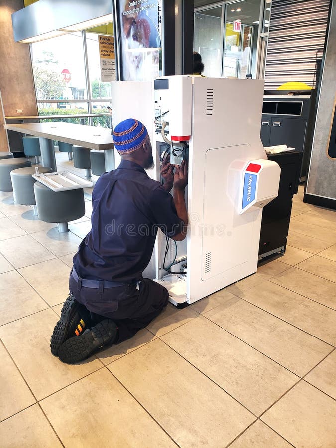 An Electrical Engineer is Setting Up and Debugging a New Automatic ...