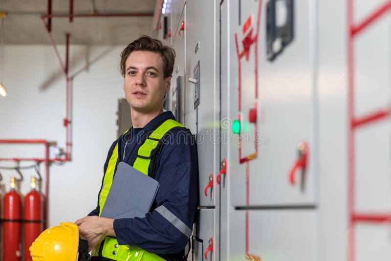 Electrical Engineer Standing Near Power Distribution Cabinet in the ...